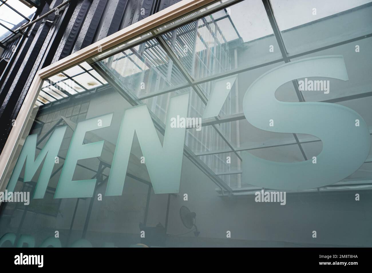 Word Men's written on window glass Stock Photo - Alamy