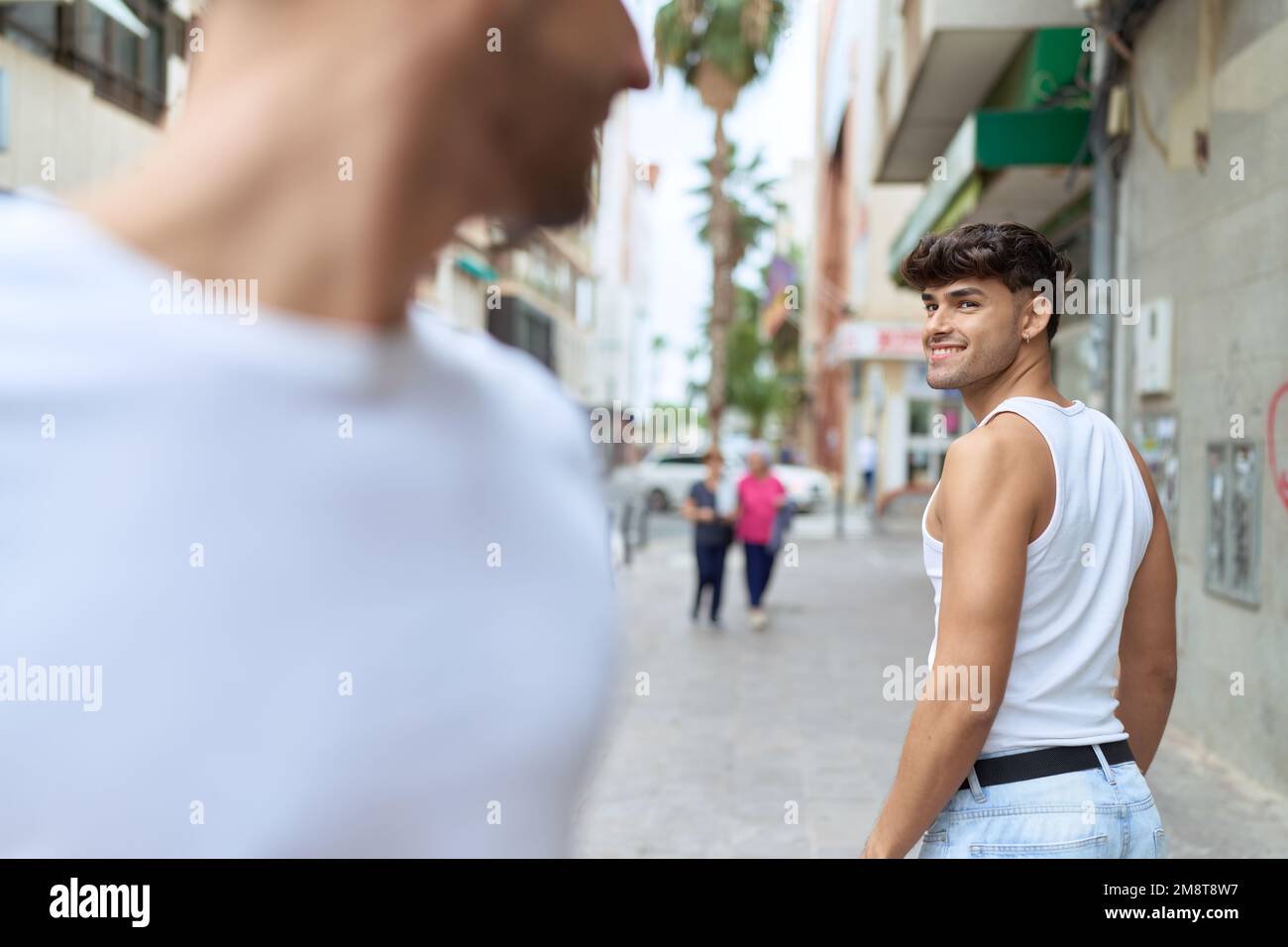 Two hispanic men couple smiling confident standing together at street ...