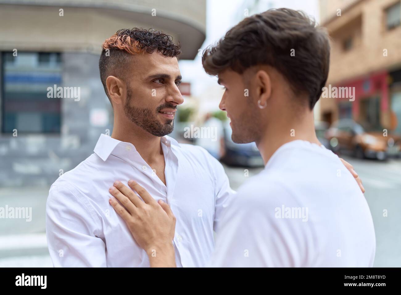 Two hispanic men couple smiling confident hugging each other at street ...