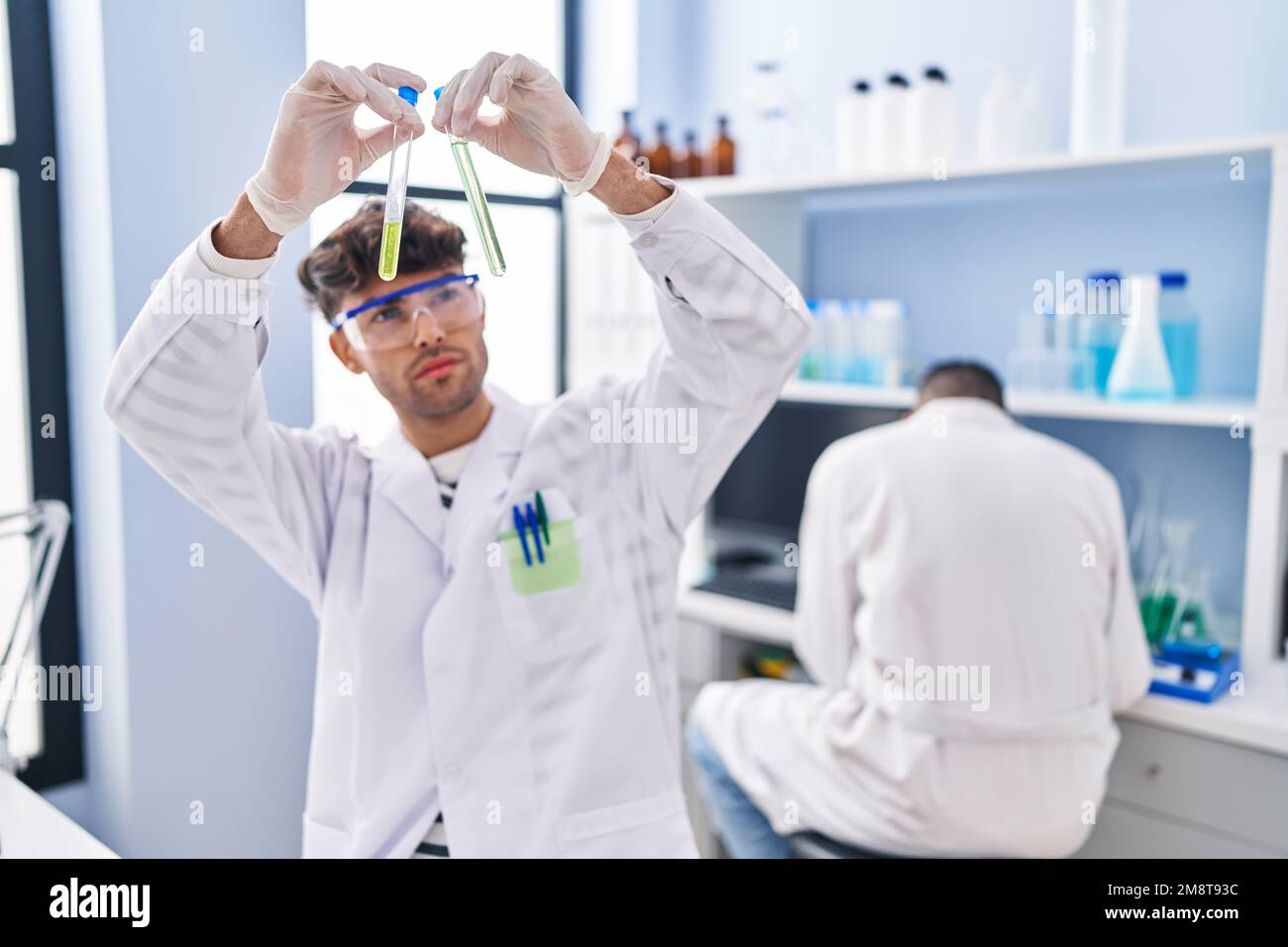 Two man scientists holding test tubes working at laboratory Stock Photo ...
