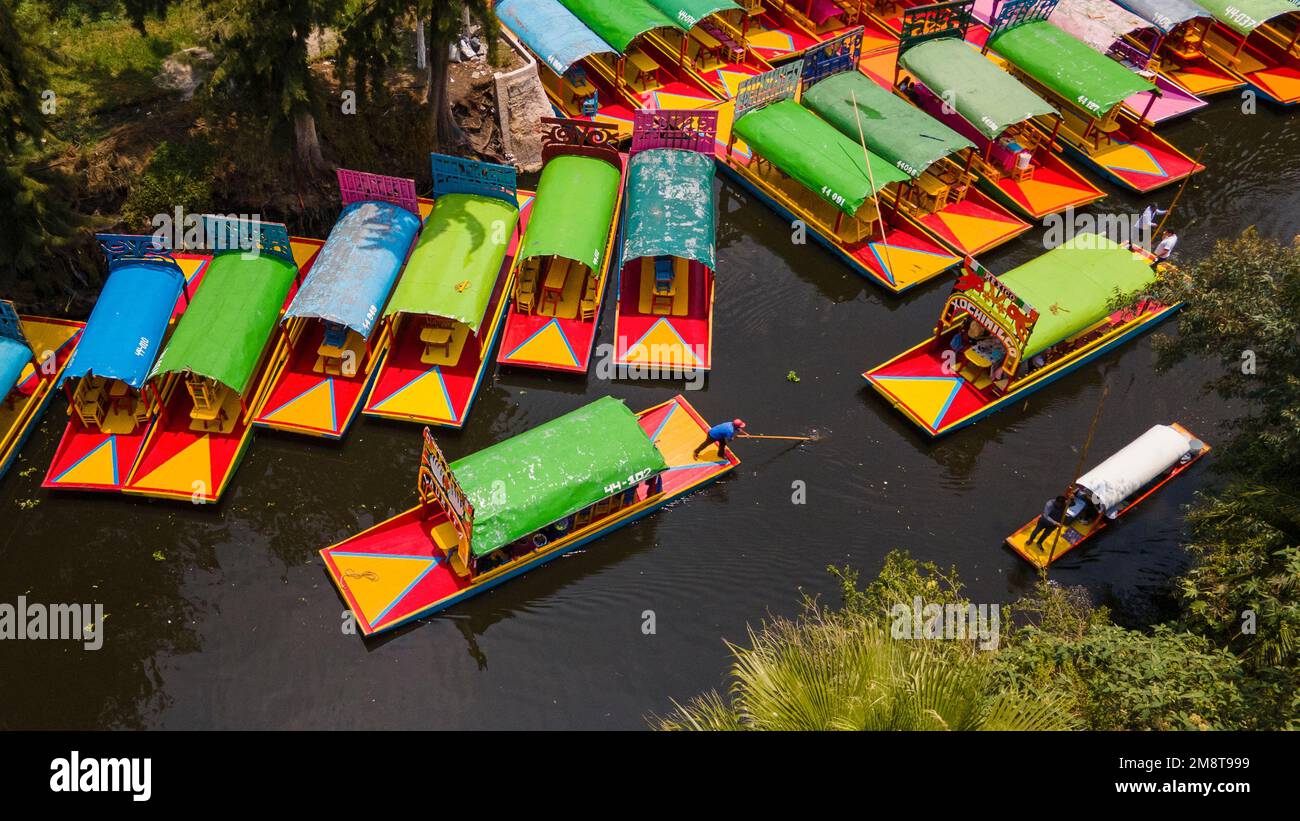 Aerial shot of colorfully painted boats in Xochimilco, Mexico City. One ...