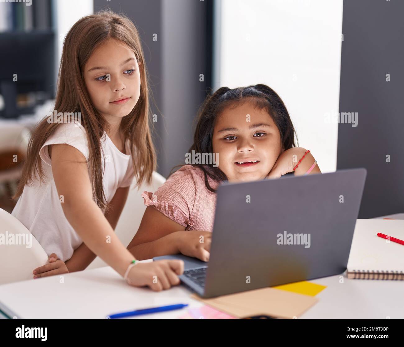 Two kids students using laptop studying at classroom Stock Photo - Alamy