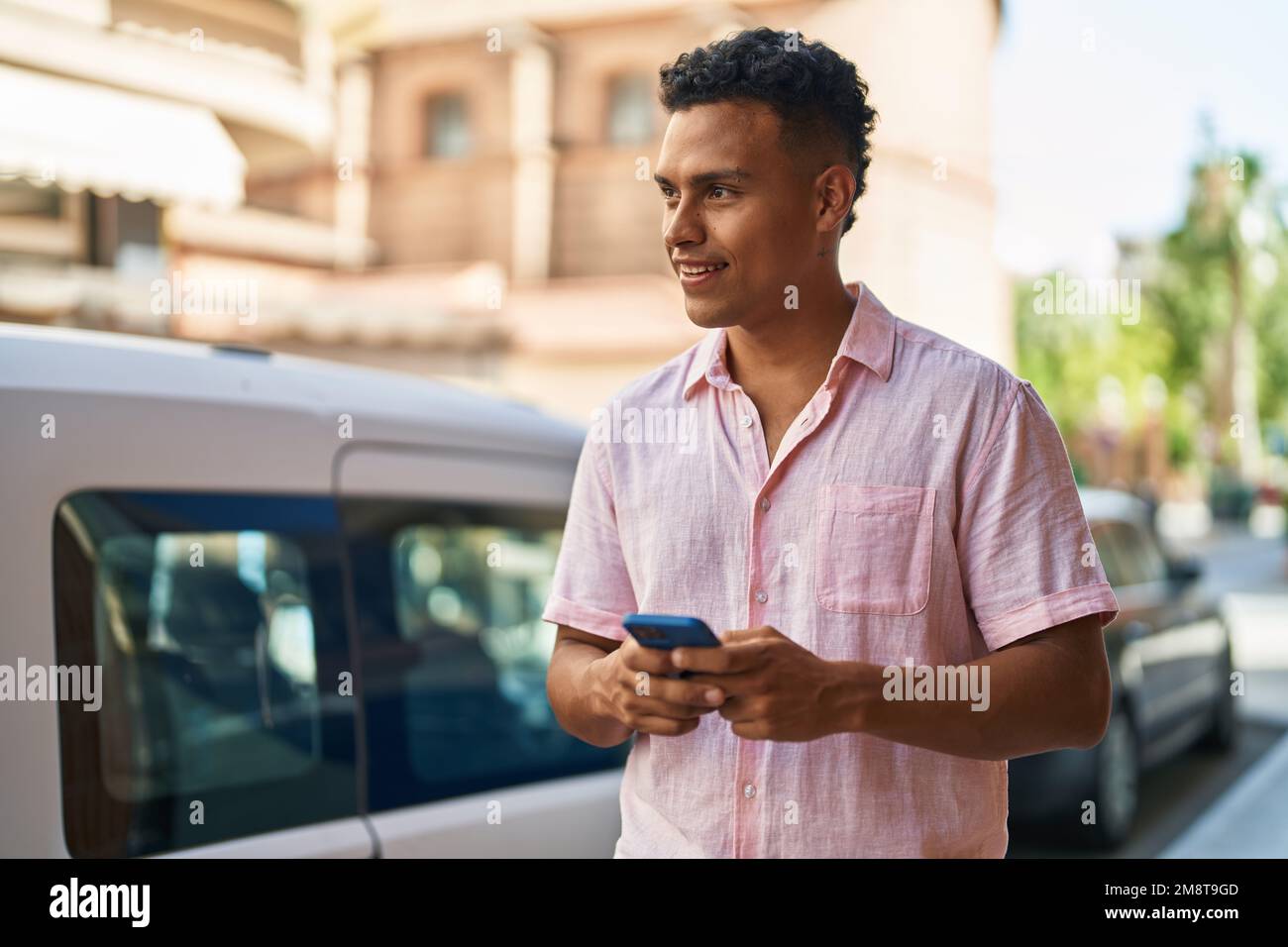 Young latin man smiling confident using smartphone at street Stock ...