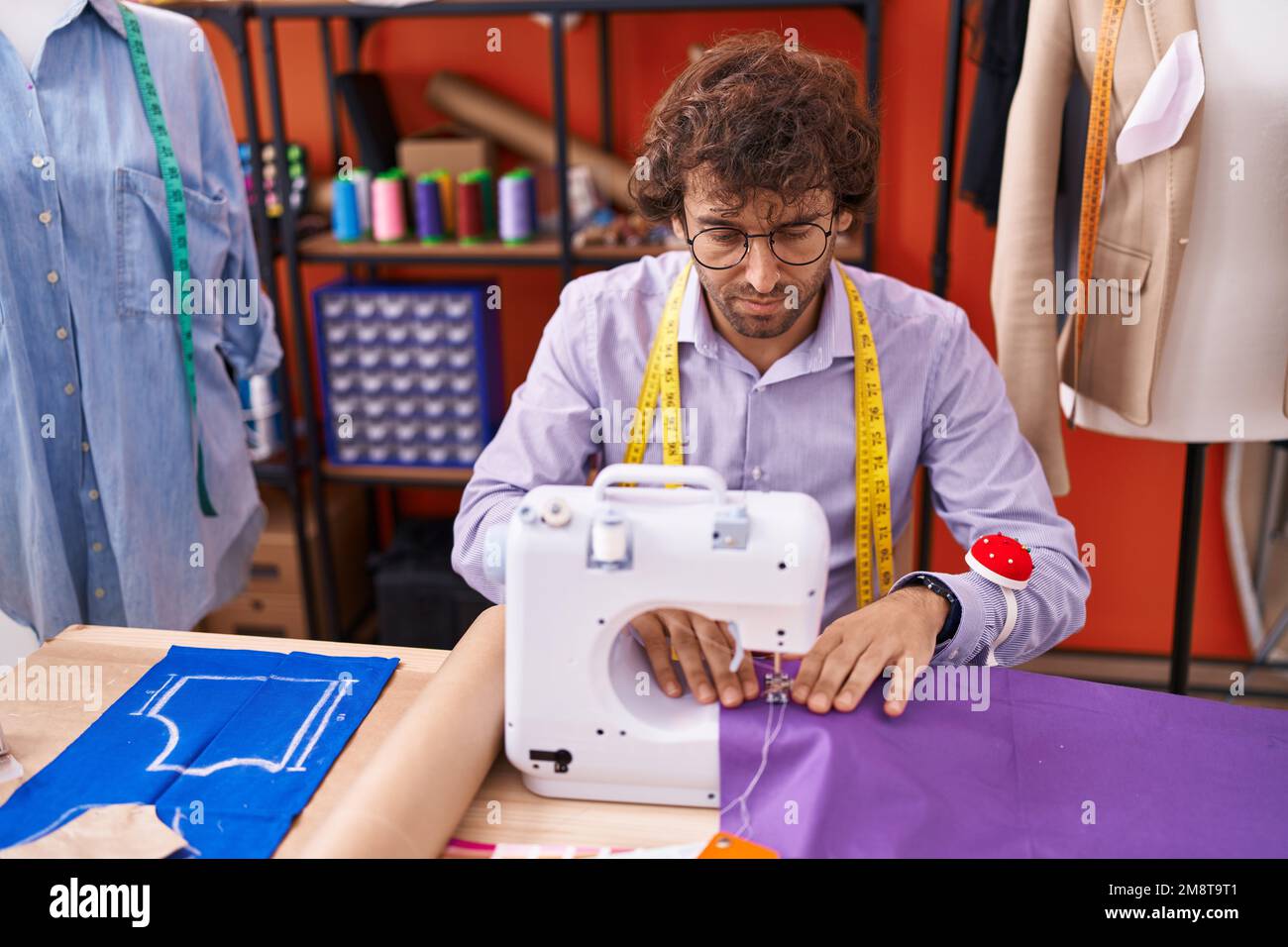 Serious handsome tailor sewing hi-res stock photography and images - Alamy
