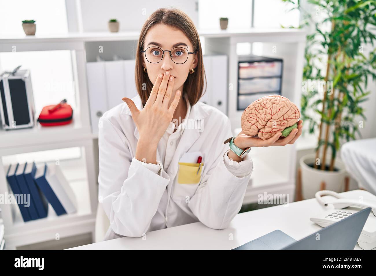 Young caucasian doctor woman holding brain as mental health concept ...