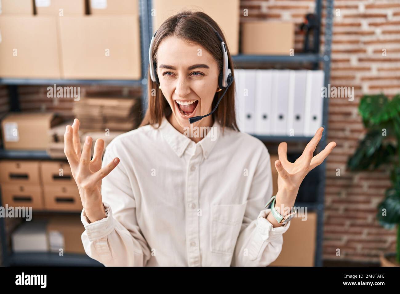 Young caucasian woman working at small business ecommerce wearing ...