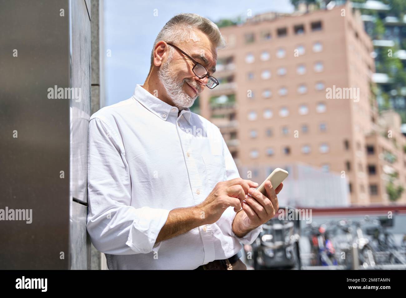 Happy old professional business man holding mobile phone using cell in ...