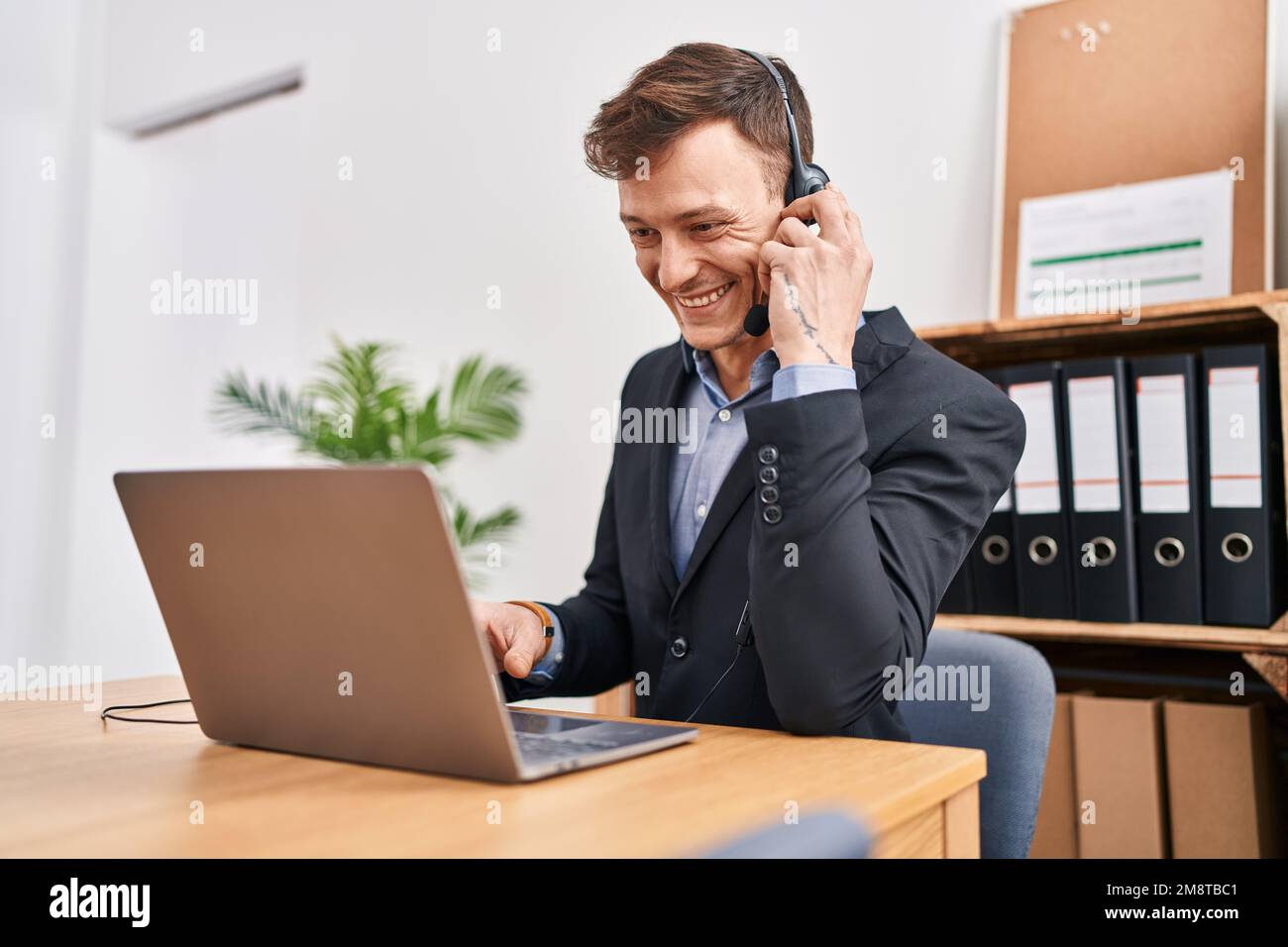 Young man call center agent smiling confident speaking at office Stock ...