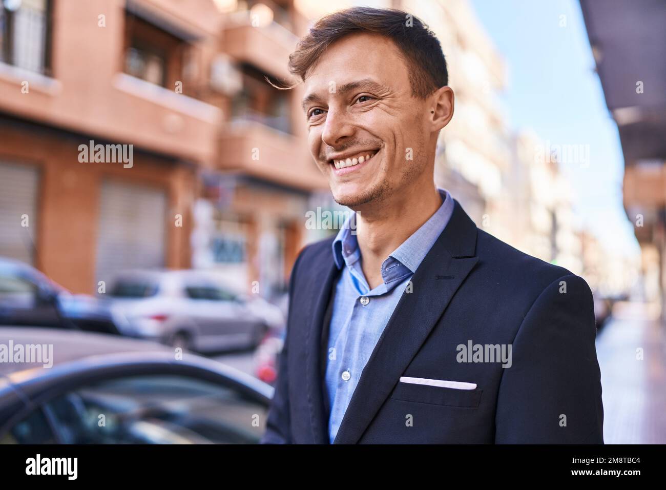 Young man business worker smiling confident standing at street Stock ...