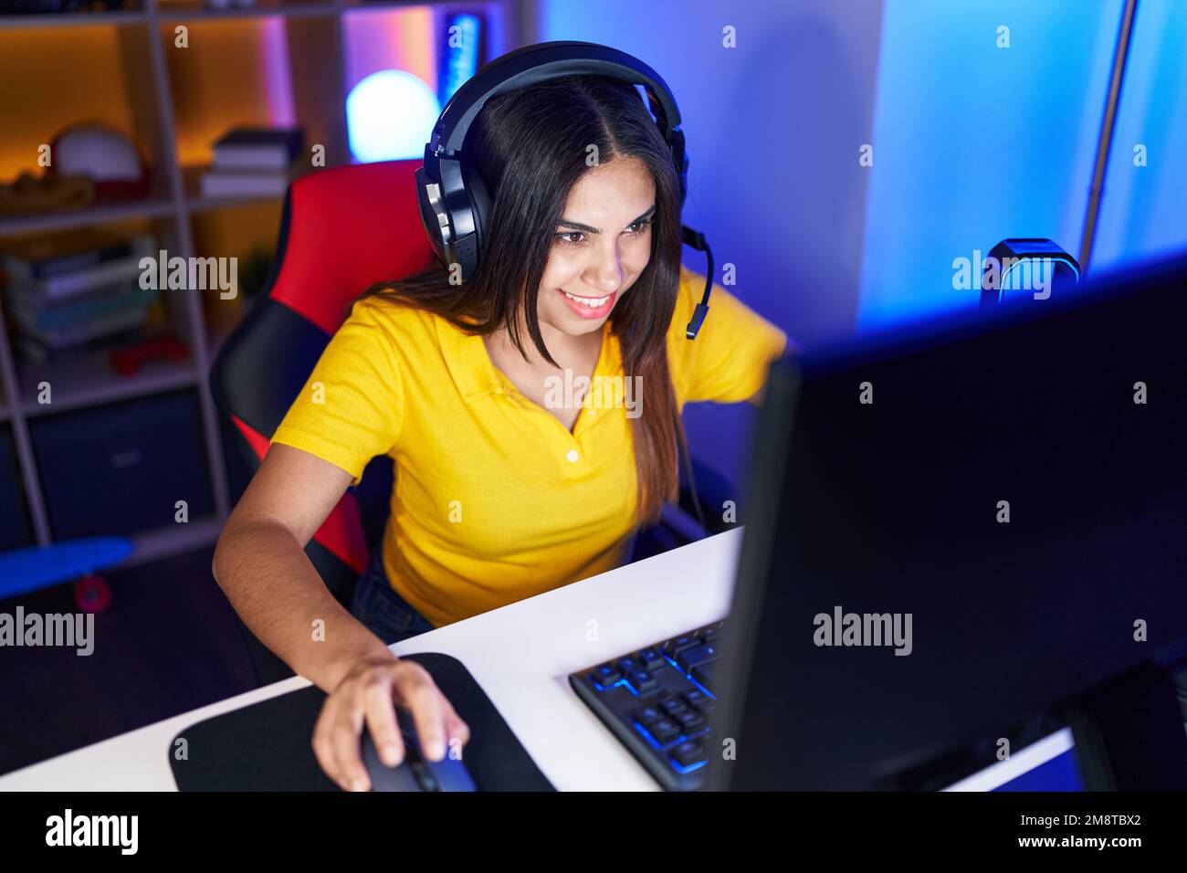 Young beautiful arab woman streamer playing video game using computer ...