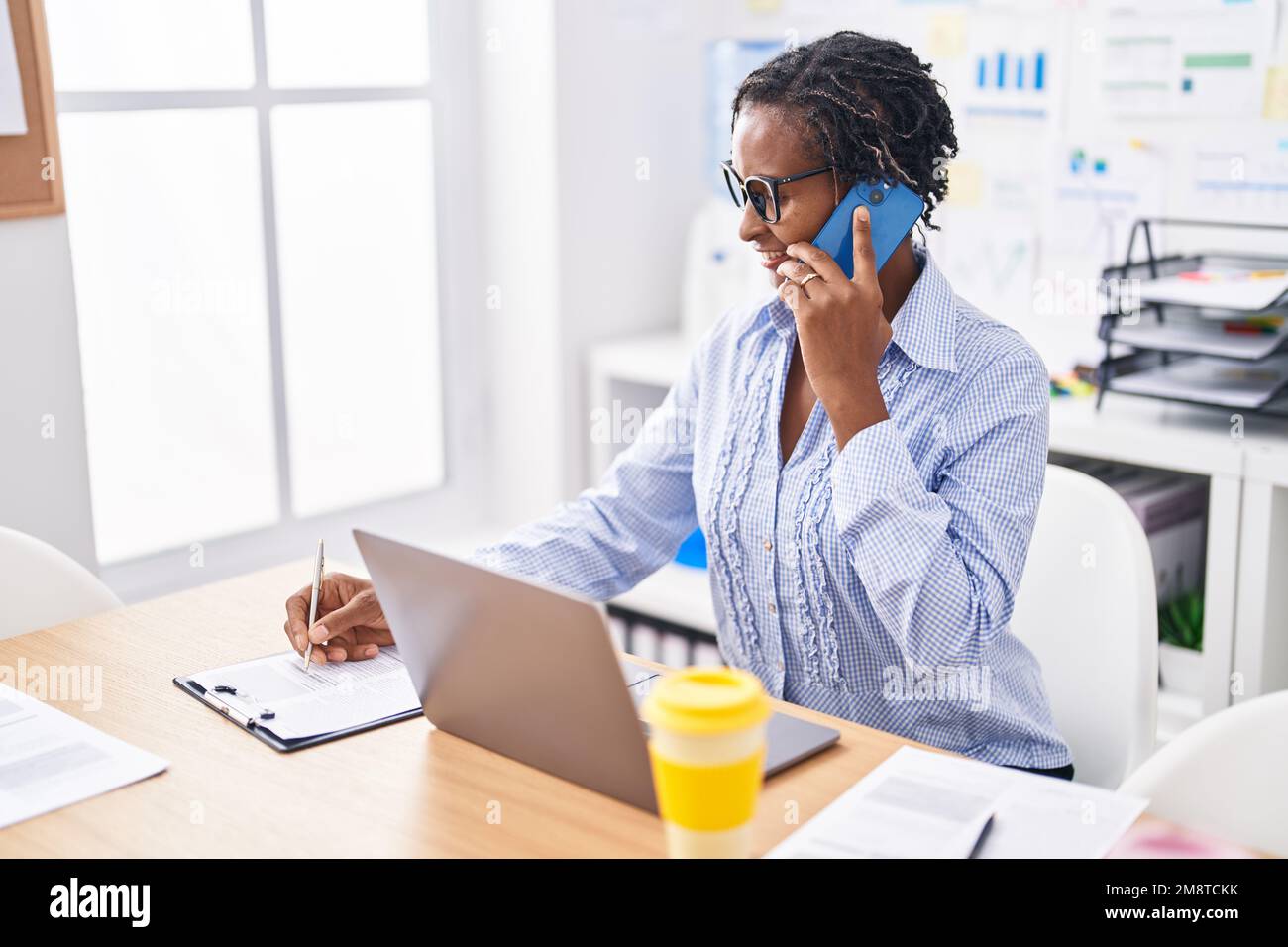 Middle age african american woman business worker talking on smartphone ...