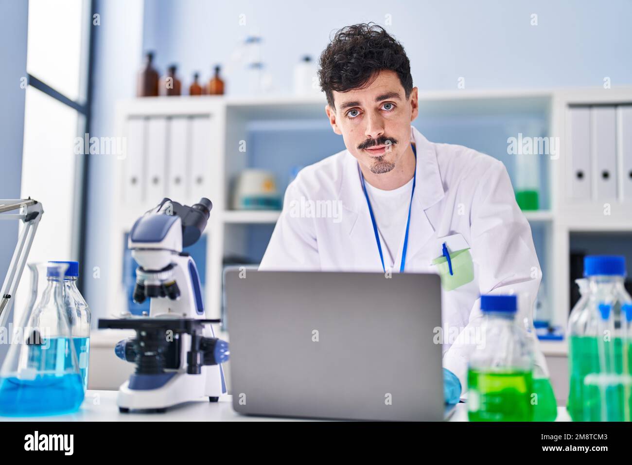 Young caucasian man scientist using laptop at laboratory Stock Photo ...