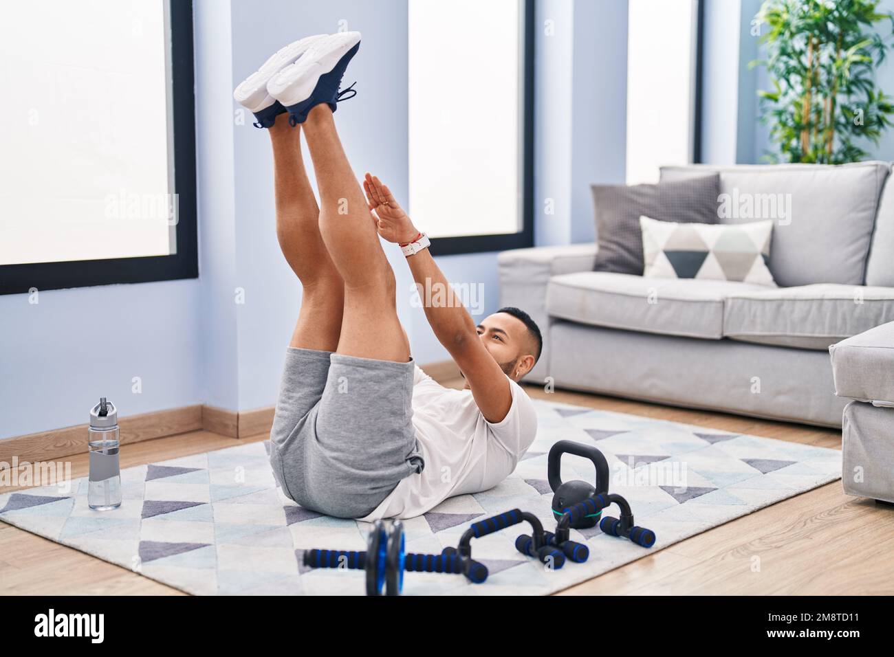 African american man smiling confident training abs exercise at home ...