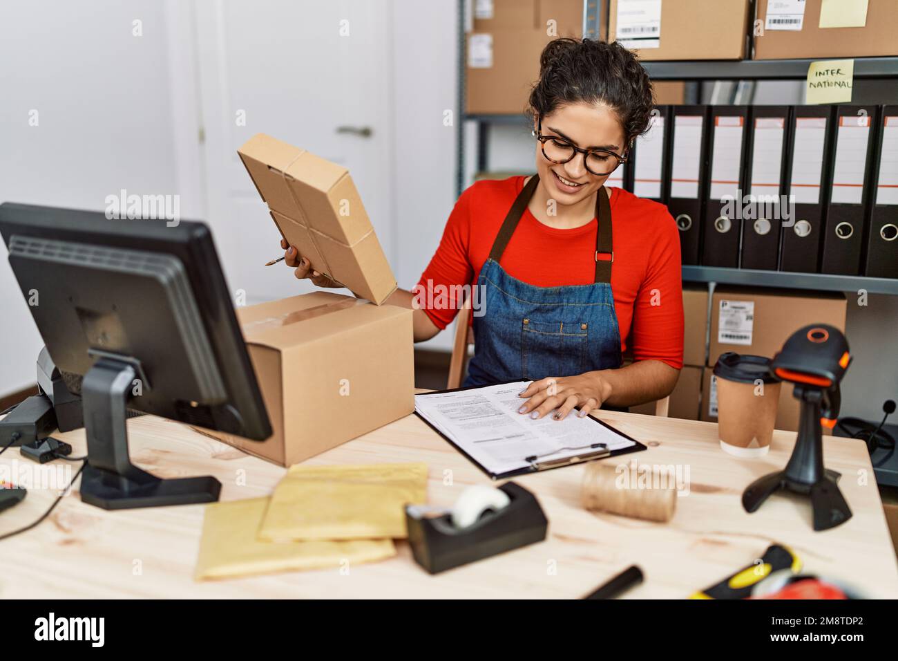 Young latin woman ecommerce business worker working at office Stock ...