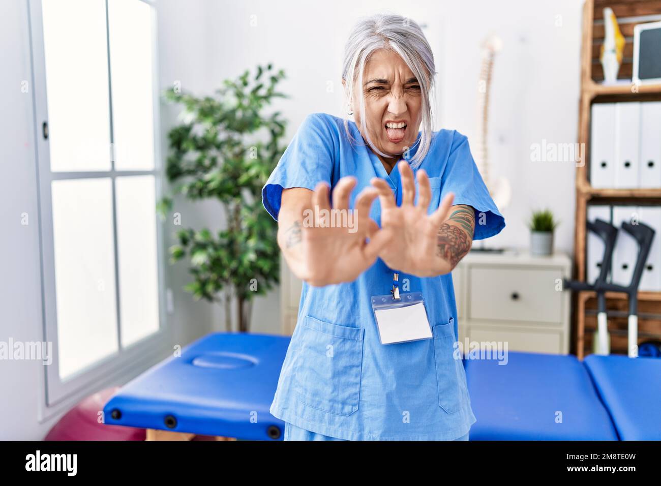 Grey haired female therapist wearing hi-res stock photography and ...