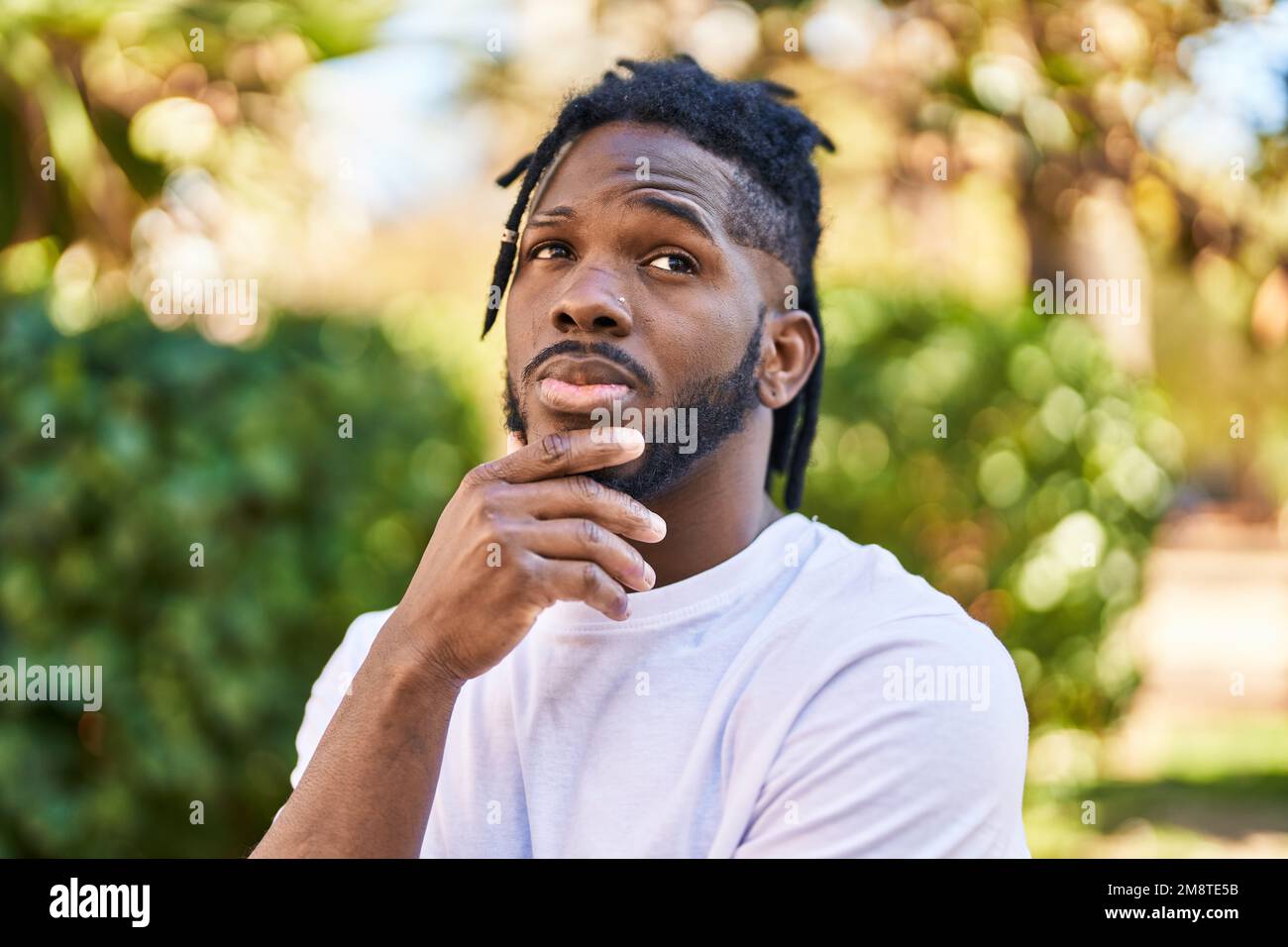 African american woman standing with doubt expression at park Stock ...