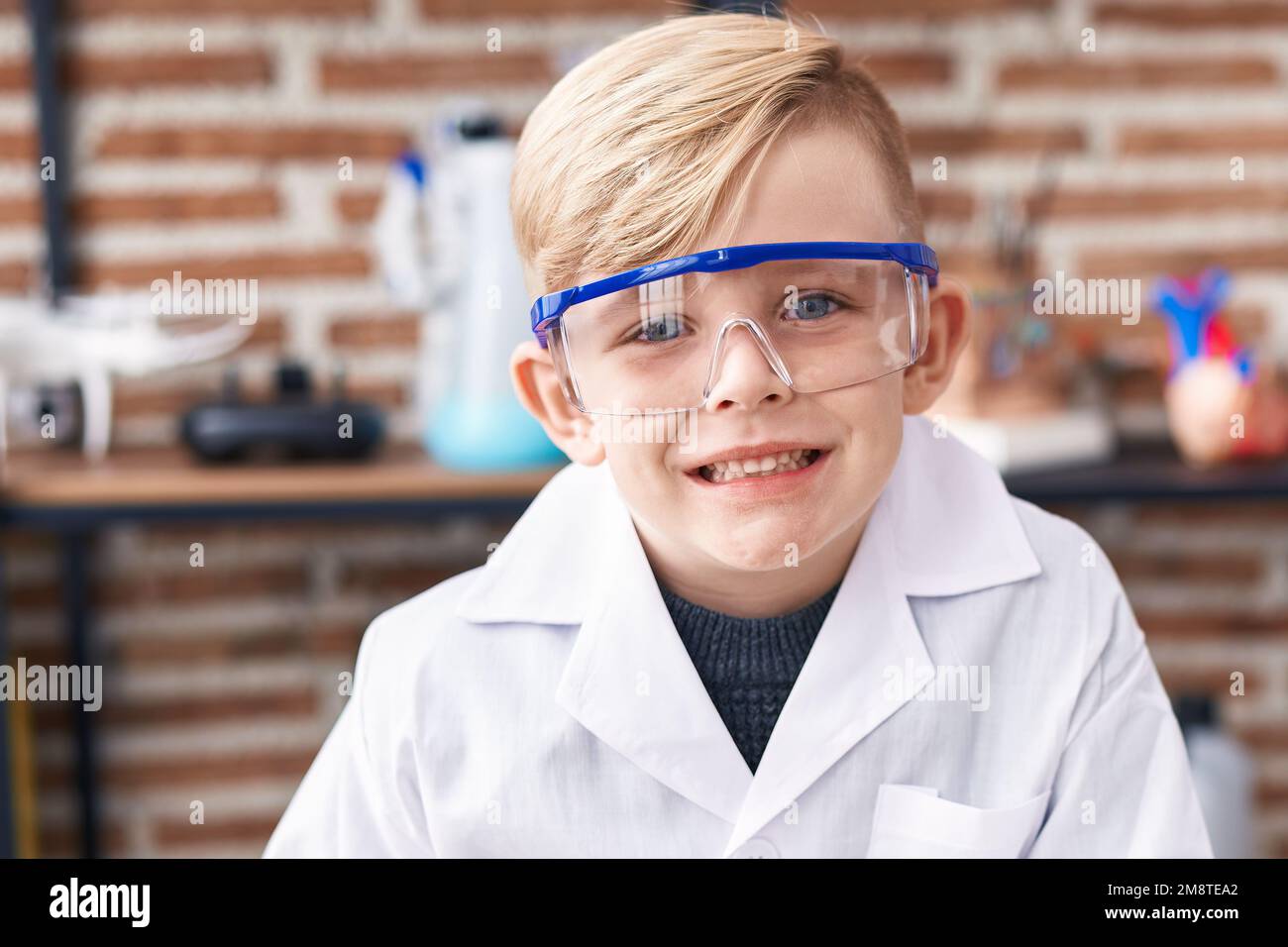 Adorable toddler scientist smiling confident standing at classroom ...