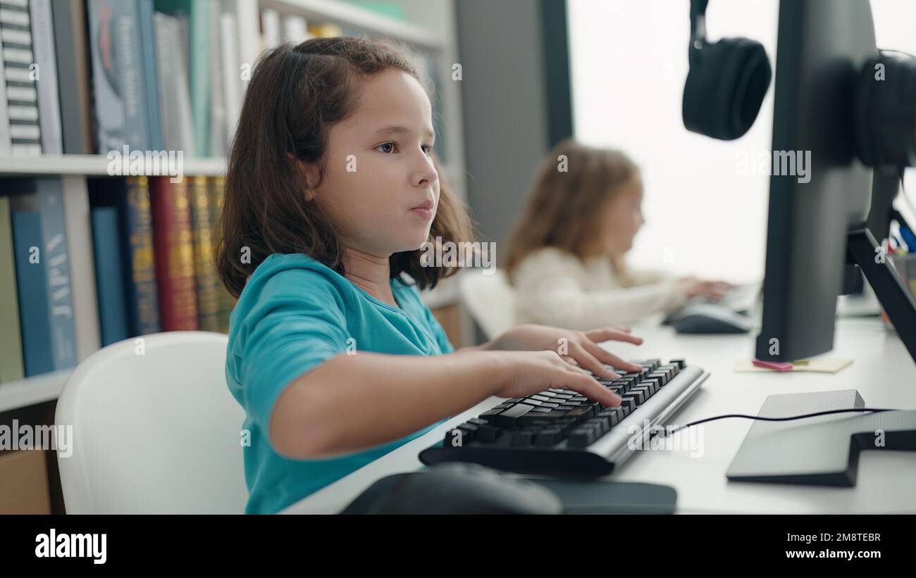 Two kids students using computer studying at classroom Stock Photo - Alamy