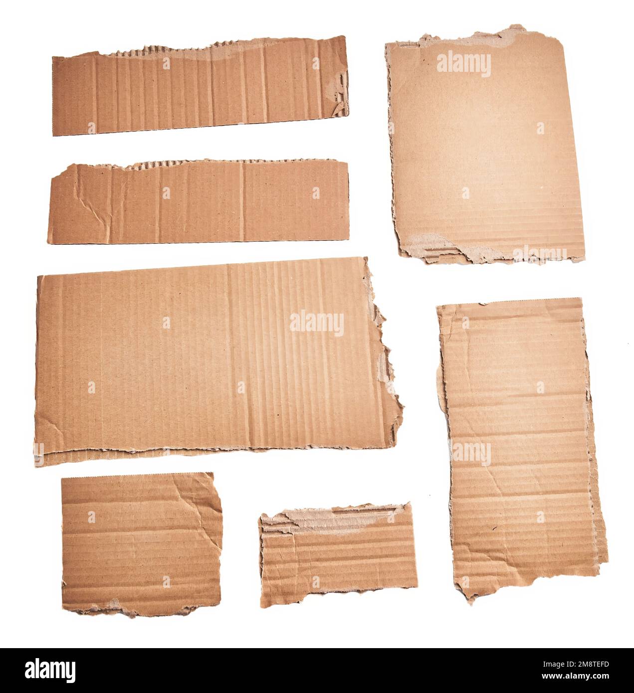 Ripped pieces of cardboard material over isolated white background ...