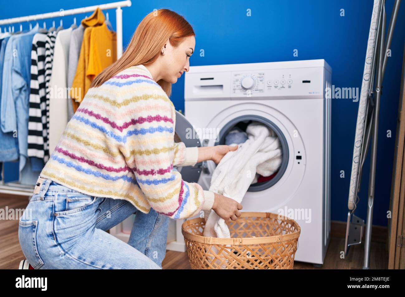 Young caucasian woman washing clothes at laundry room Stock Photo - Alamy