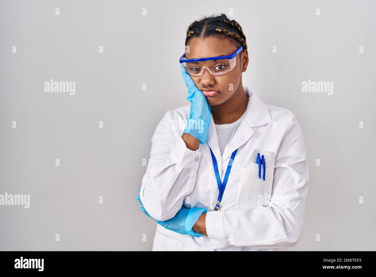 African american woman with braids wearing scientist robe thinking ...