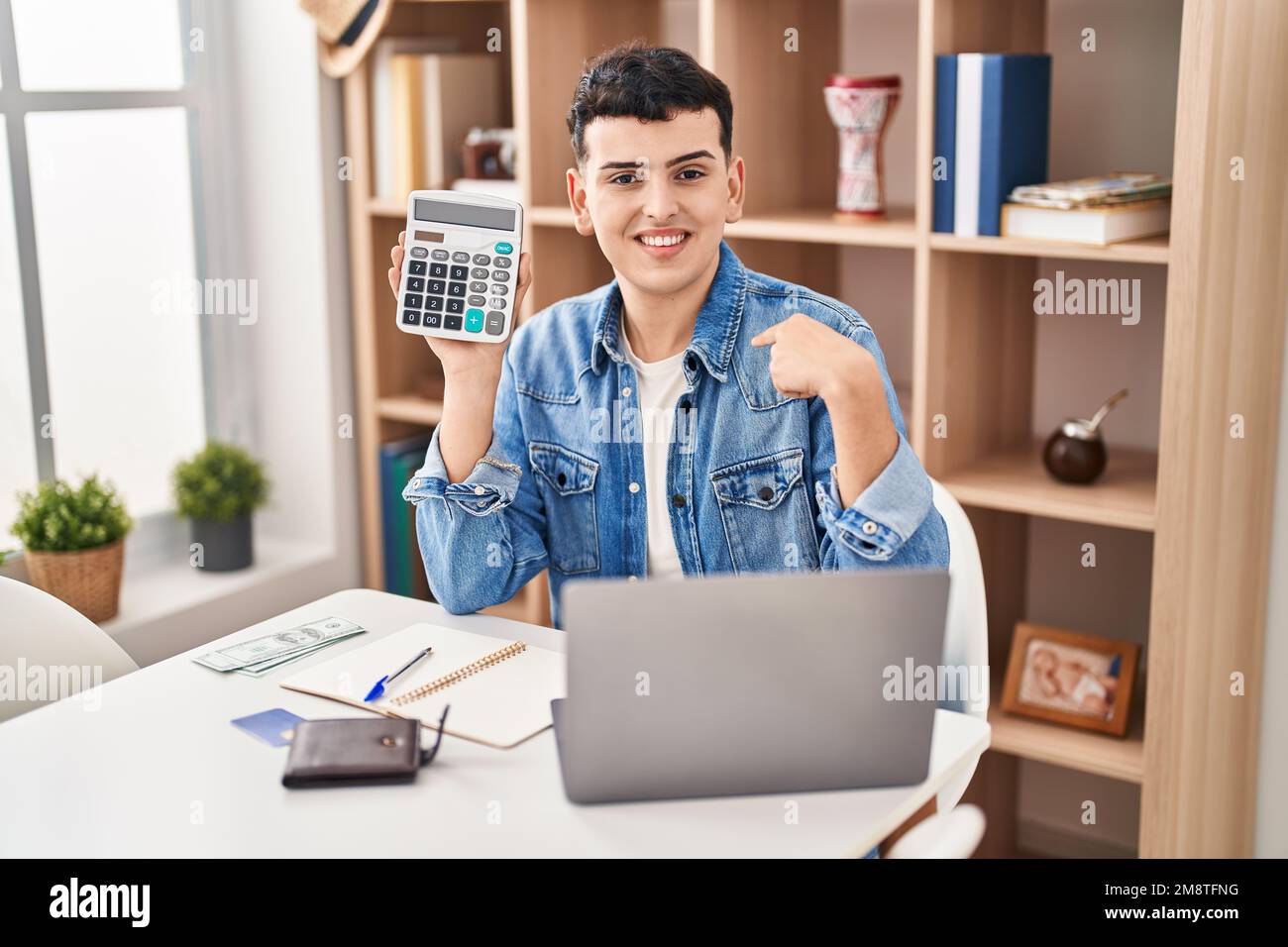 Non binary person calculating money savings pointing finger to one self ...