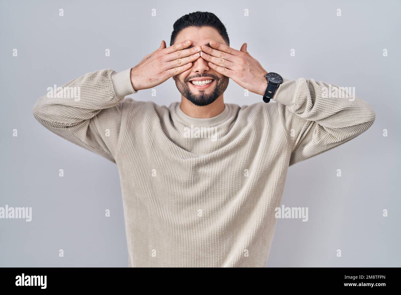 Young handsome man standing over isolated background covering eyes with ...