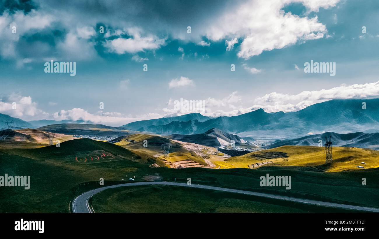 An Aerial photograph of Riyue mountain, a road, and yellow fields in ...