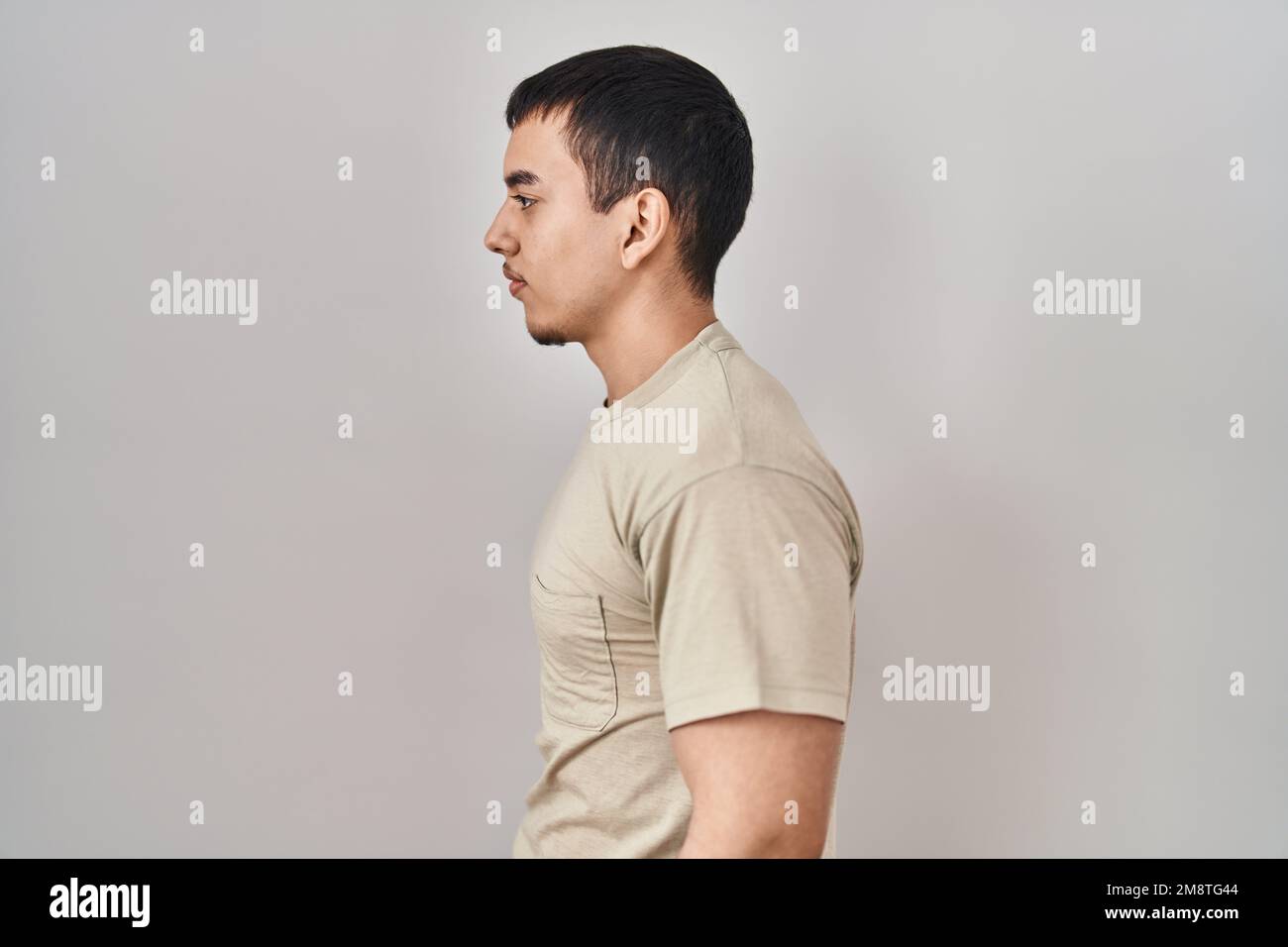 Young arab man wearing casual t shirt looking to side, relax profile ...