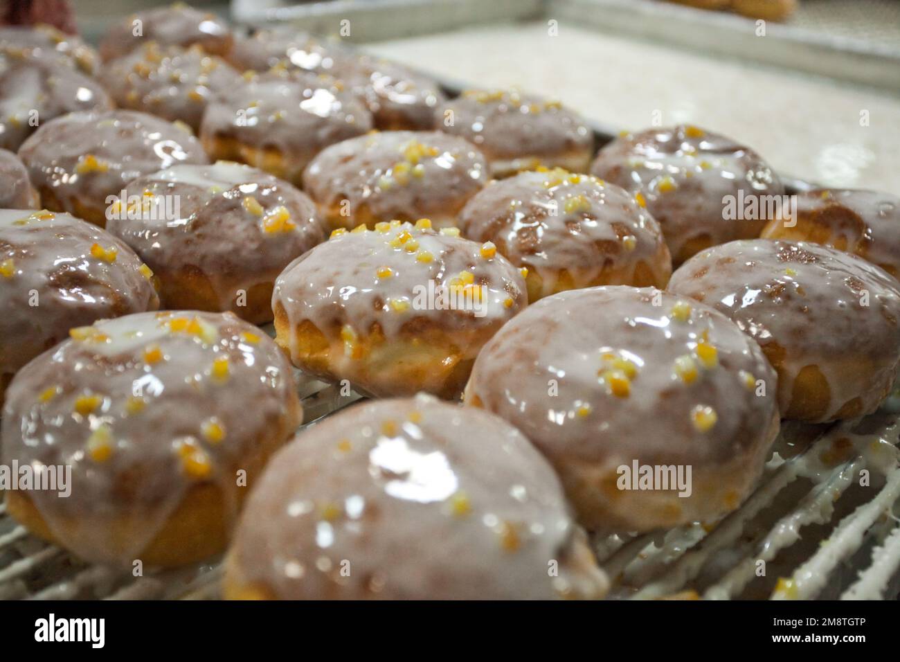 Baking donuts in a pastry shop. Traditional Polish Fat Thursday. donut ...
