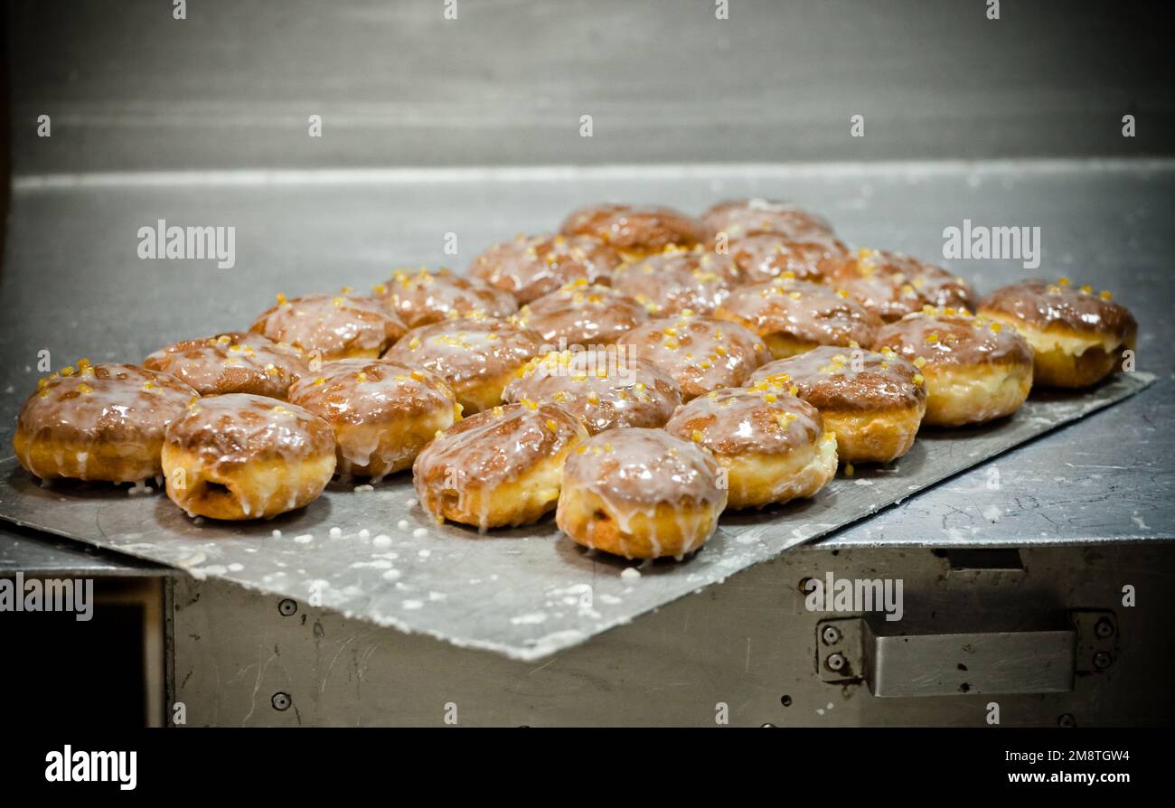 Baking donuts in a pastry shop. Traditional Polish Fat Thursday. donut ...