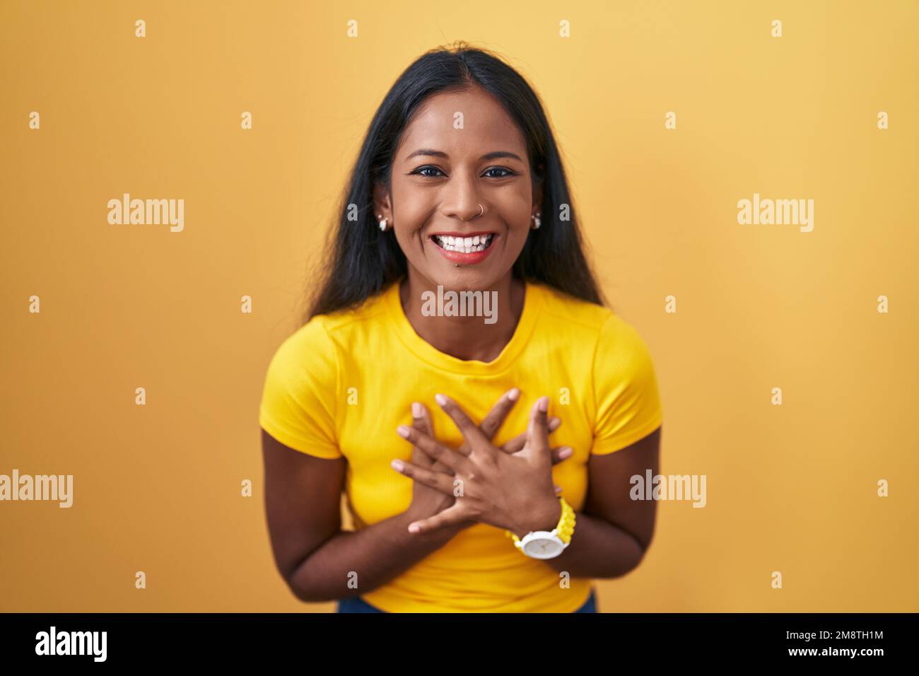 Young Indian Woman Standing Over Yellow Background Smiling And Laughing Hard Out Loud Because