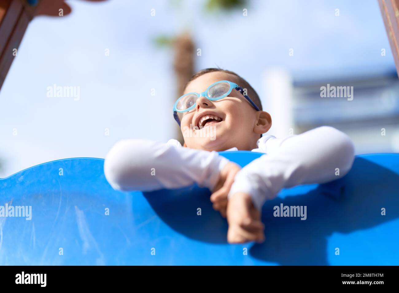 Adorable hispanic toddler smiling confident playing on slide at park playground Stock Photo - Alamy