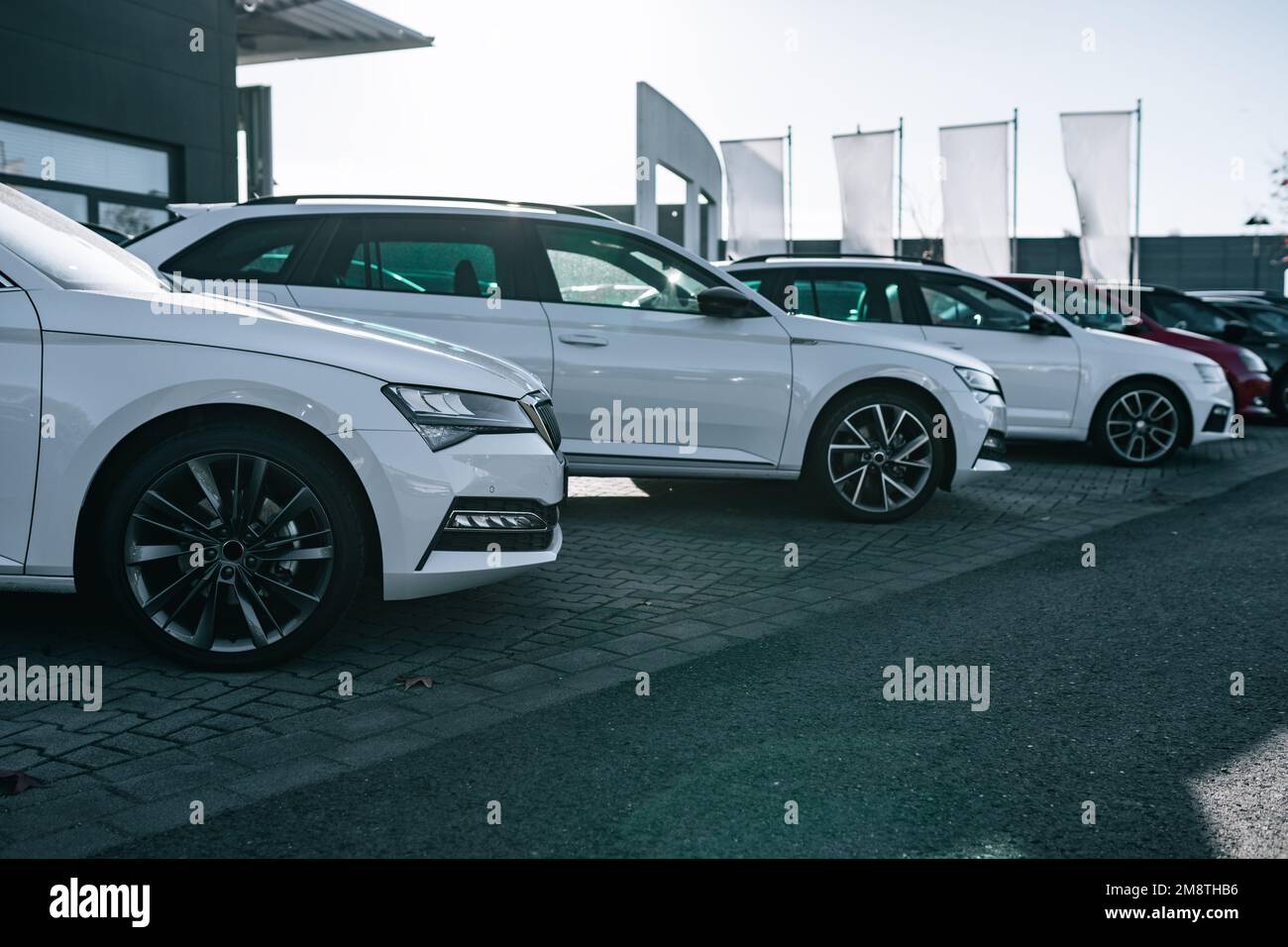 Three parked white cars in a station Stock Photo - Alamy