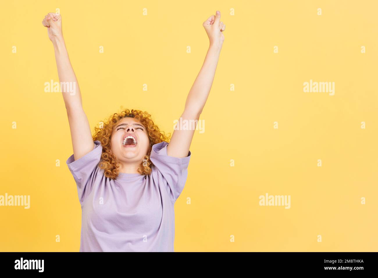 Woman celebrating while raising the arms and shouting Stock Photo - Alamy