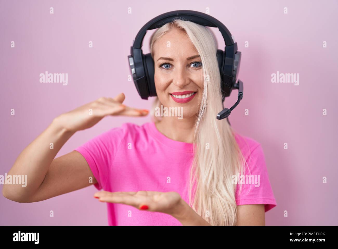 Caucasian woman listening to music using headphones gesturing with ...