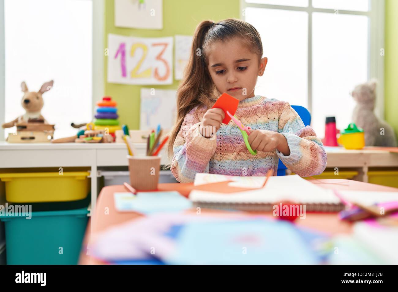 Adorable girl cutting paper hi-res stock photography and images - Alamy