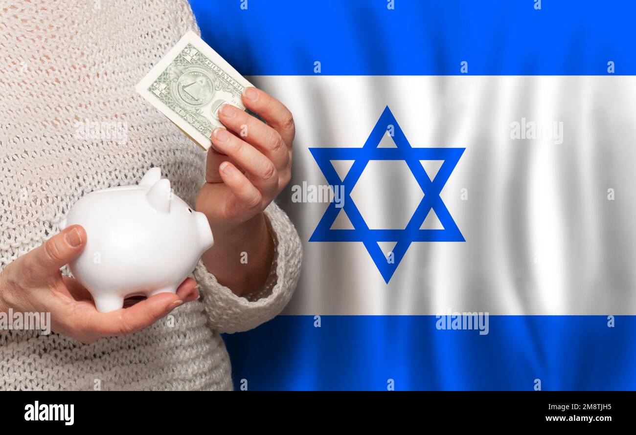 Izraeli woman with money bank on the background of Izrael flag ...