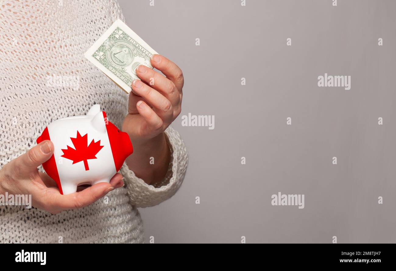Flag of Canada on money bank in Canadian woman hands. Dotations ...
