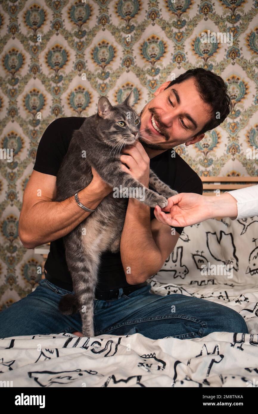 Man cat bed hi-res stock photography and images - Alamy