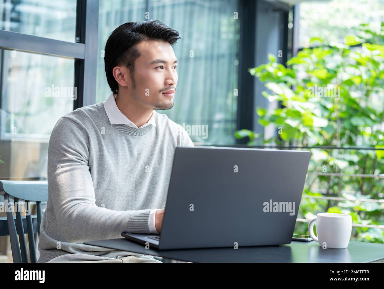 Young men who use a computer Stock Photo - Alamy