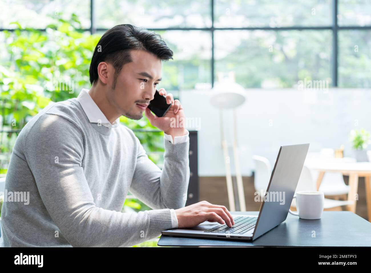 Young men who use a computer Stock Photo - Alamy