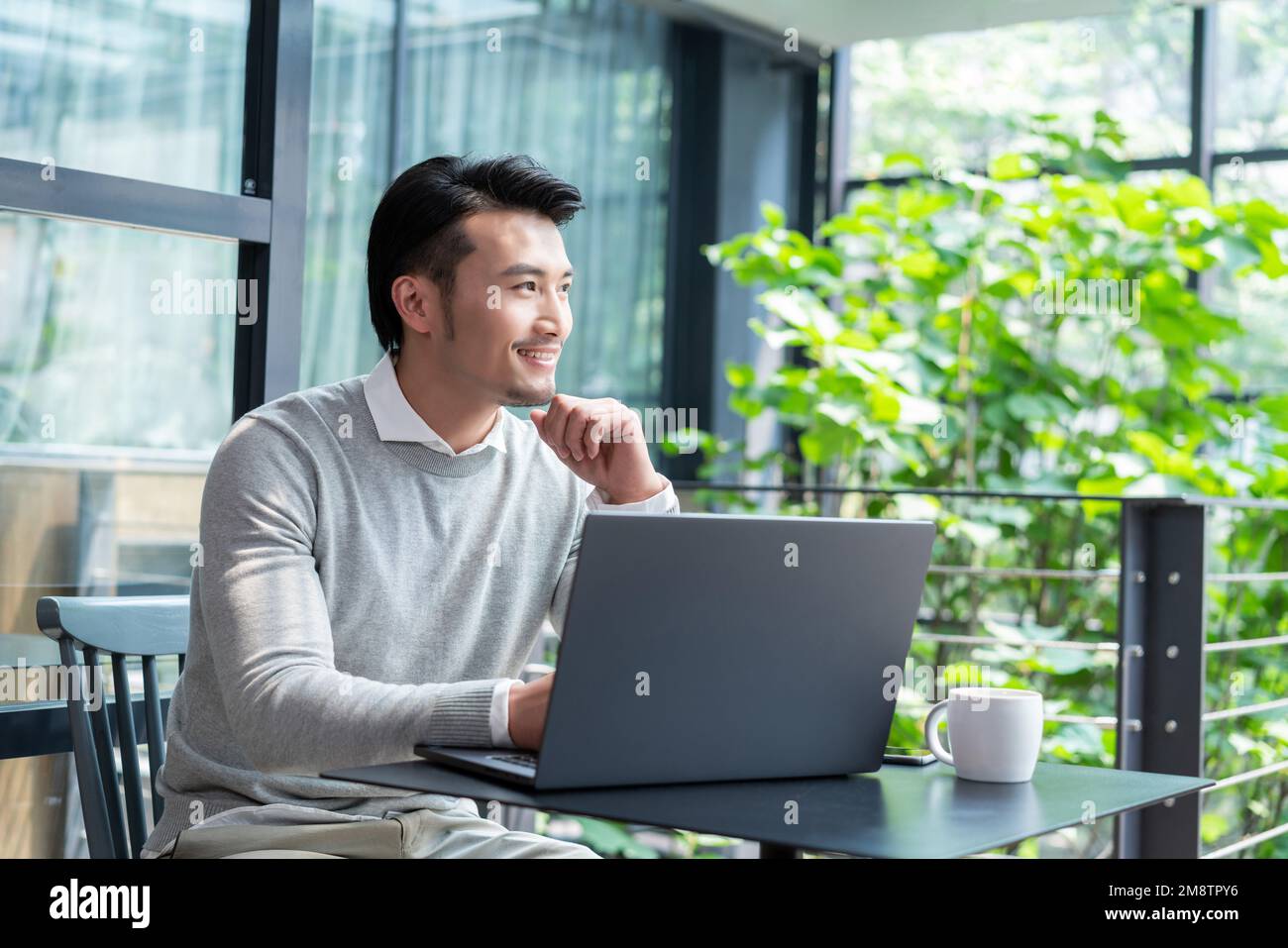 Young men who use a computer Stock Photo - Alamy