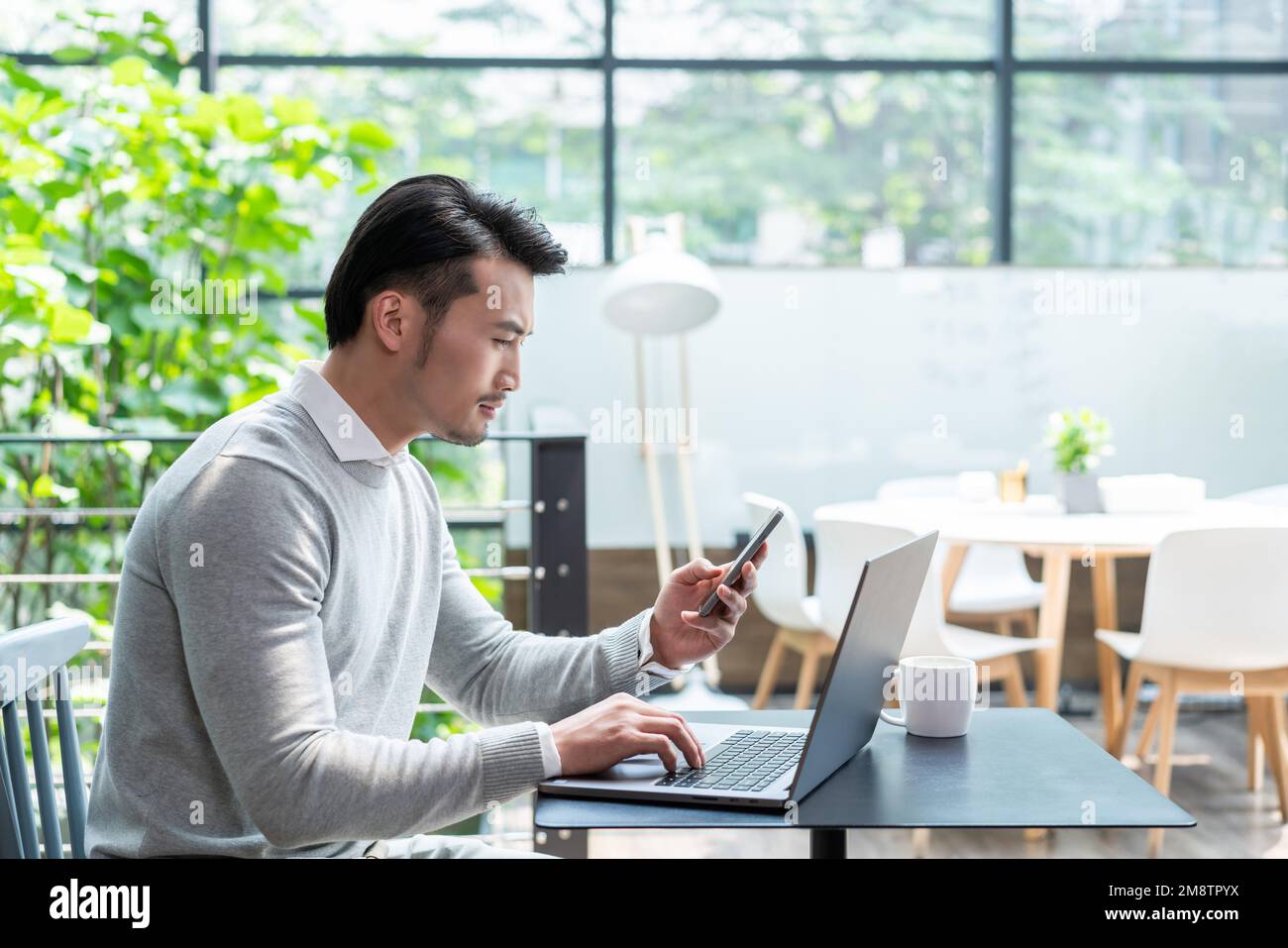 Young men who use a computer Stock Photo - Alamy