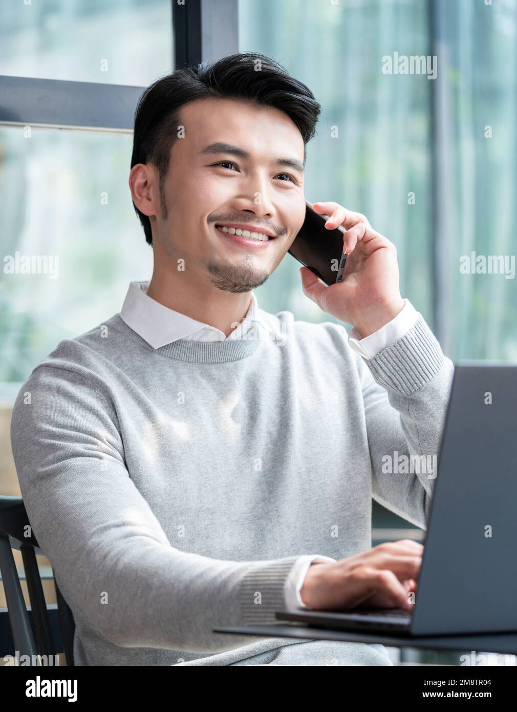 Young men who use a computer Stock Photo - Alamy