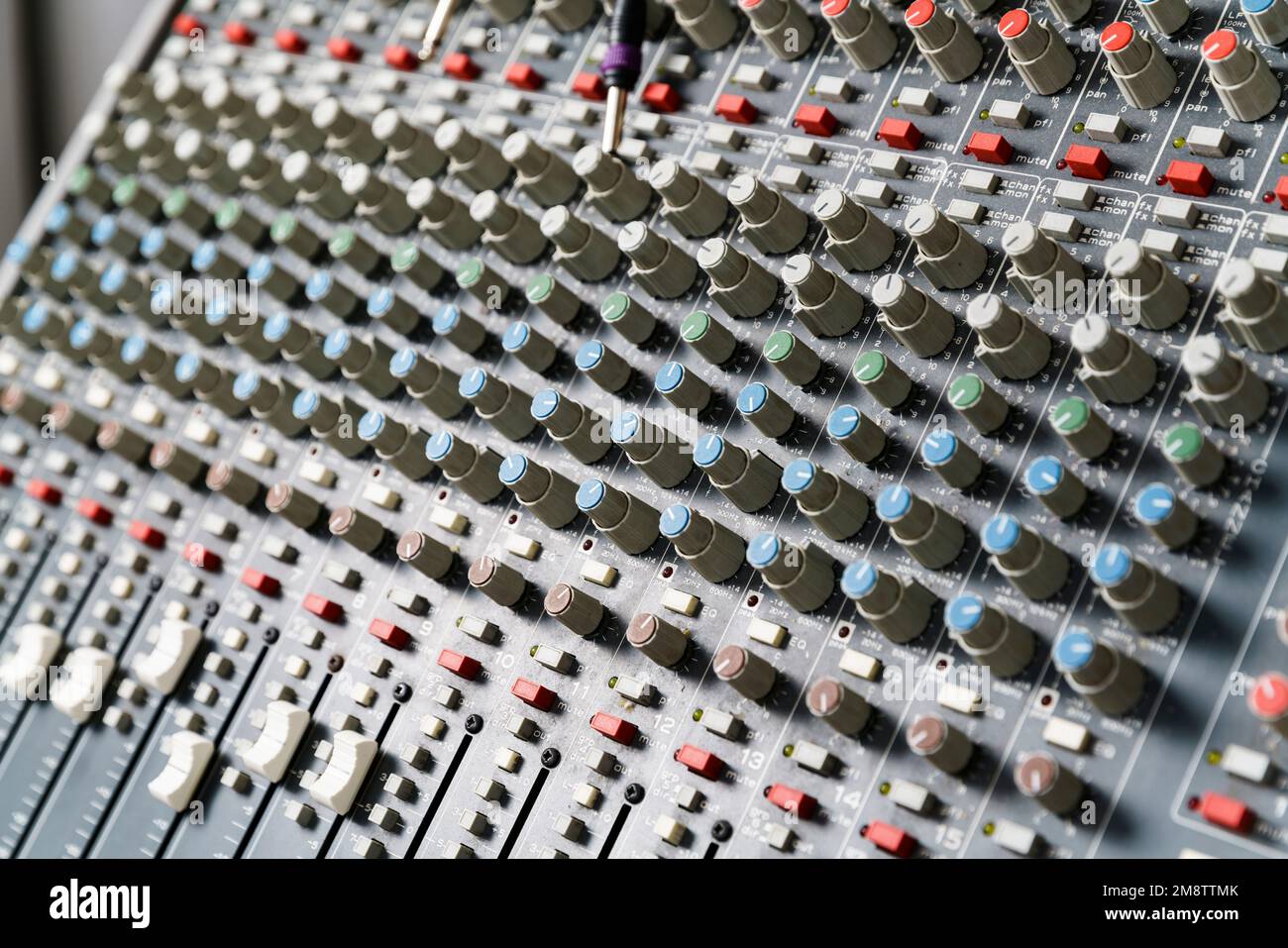 Close up detail of a dials on a mixing desk in a music recording studio ...