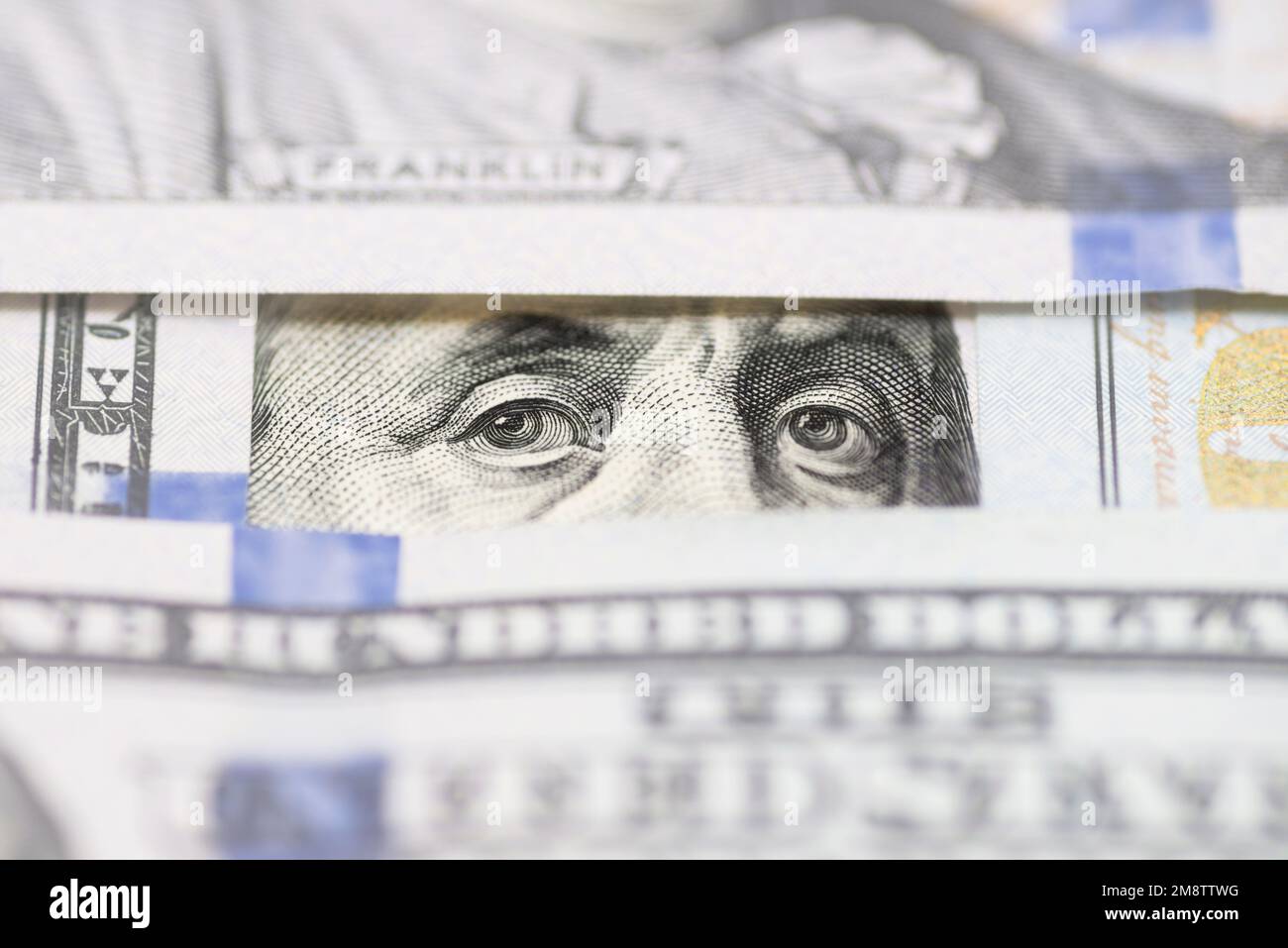 Eyes of Benjamin Franklin watching from stack of money windows Stock ...