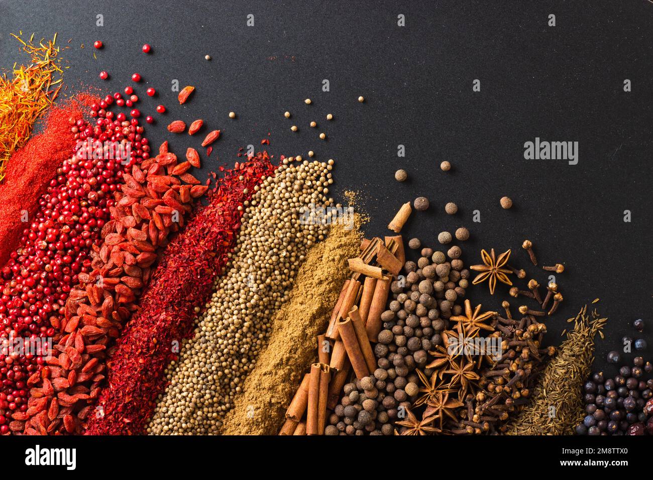 Set of flavors on blackboard background, top view. Spices for cooking ...