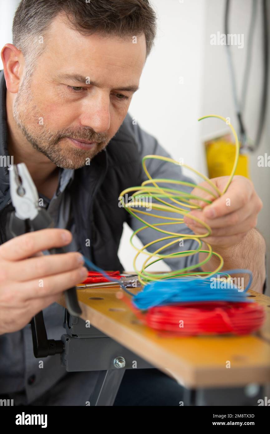 male electrician builder working with cables Stock Photo - Alamy