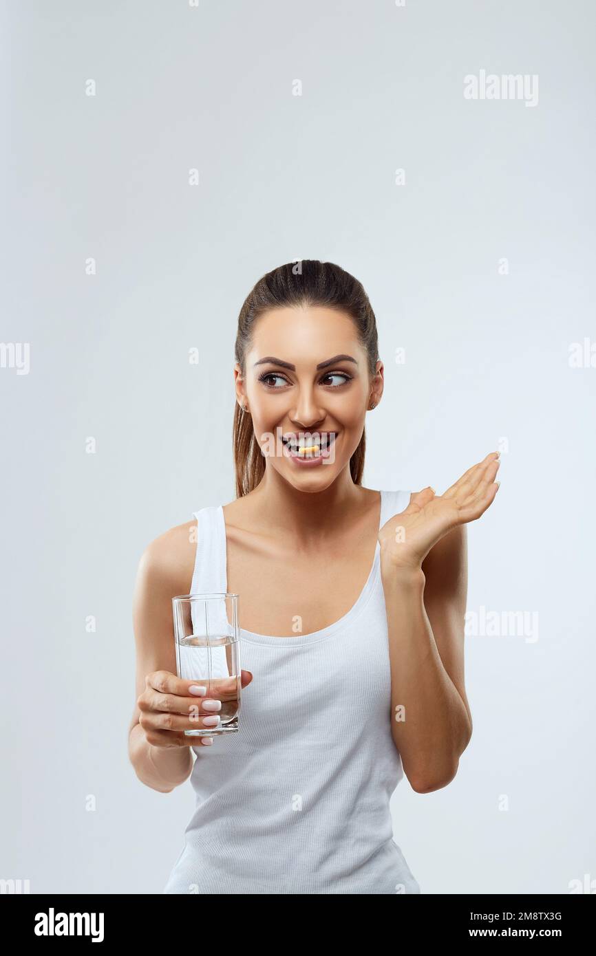 Beautiful Woman Opened Mouth Holding Vitamin Pill In White Teeth. Smiling Girl Holding Capsule ...